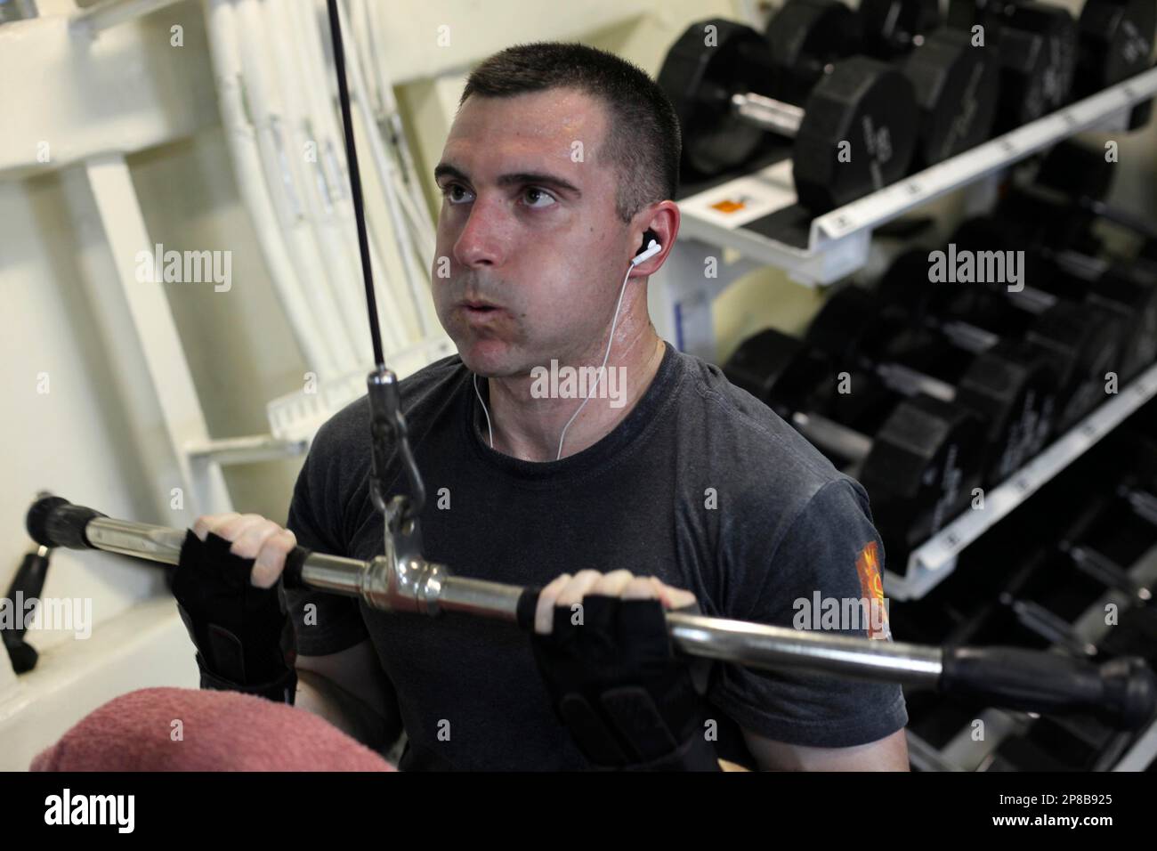 U.S Navy Lt. Chris Lebel from Austin, Texas trains in a small gym ...