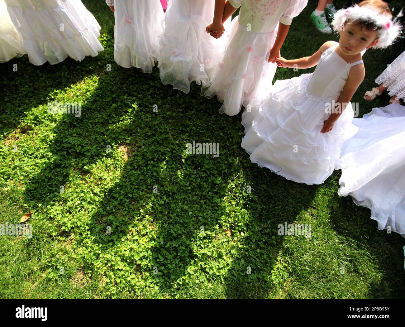 Girls dressed in wedding dress attend during the celebrations of the ...