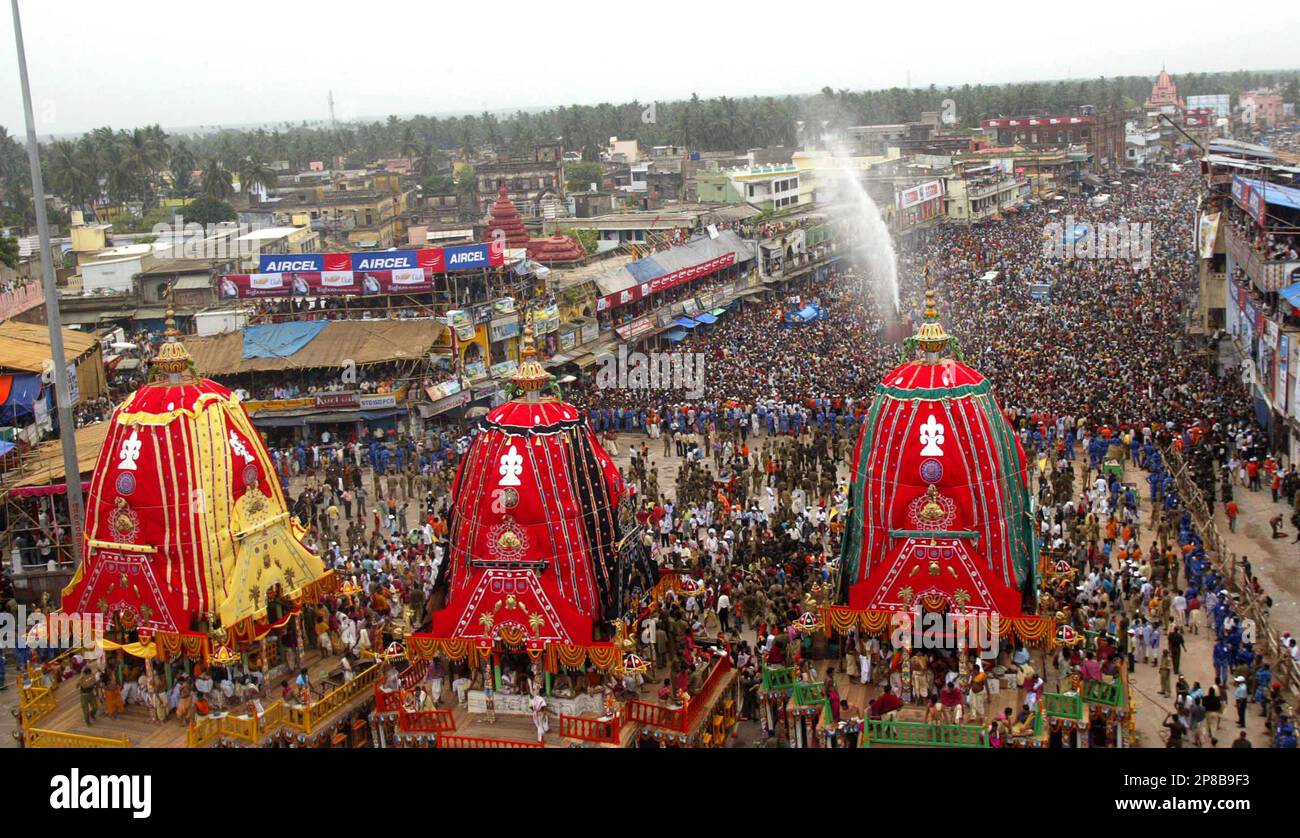 Devotees gather near chariots carrying statues of Hindu Gods Jagannath ...