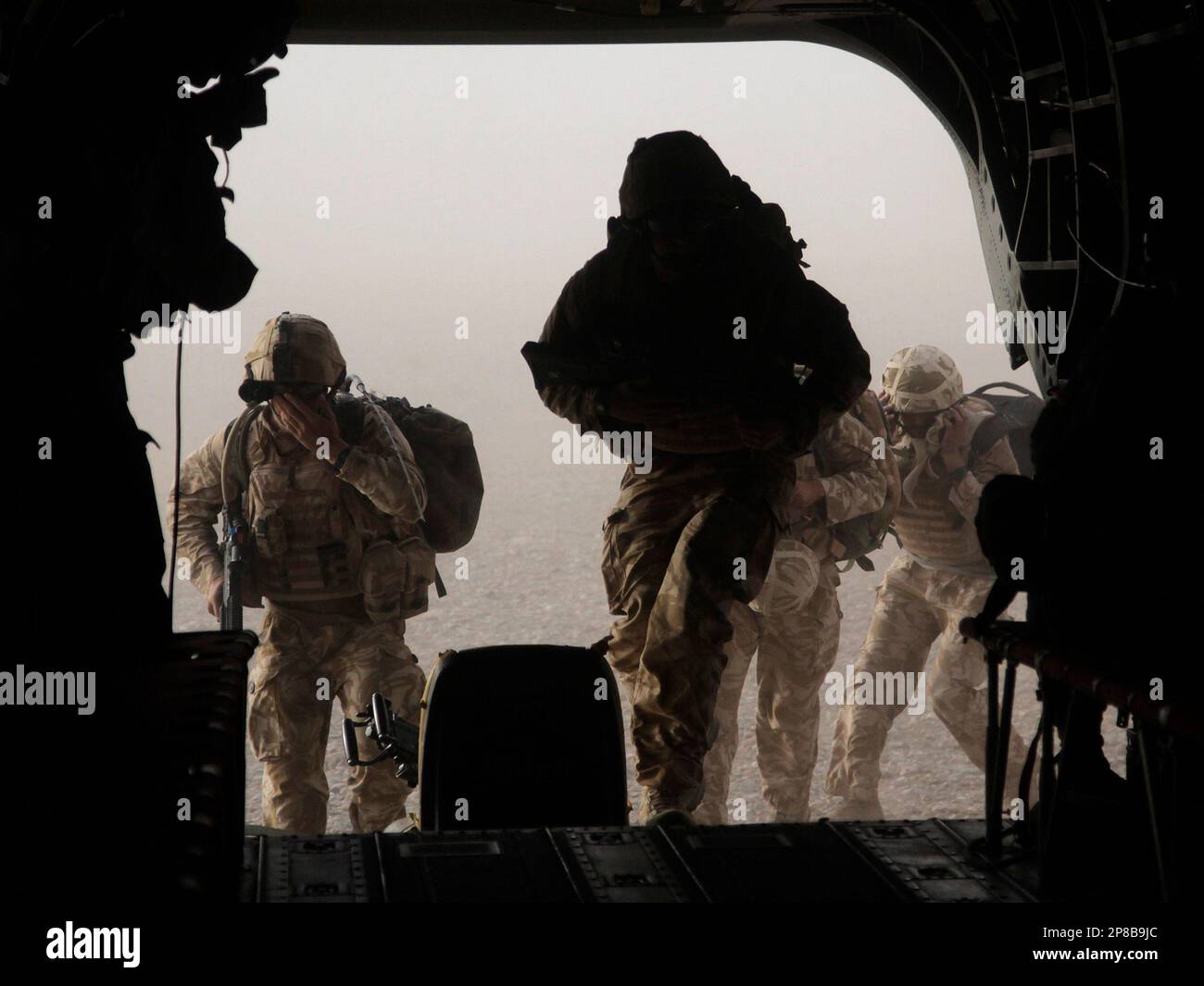 Scottish troops from the 19th Light Brigade board a U.S. CH-47 Chinook ...