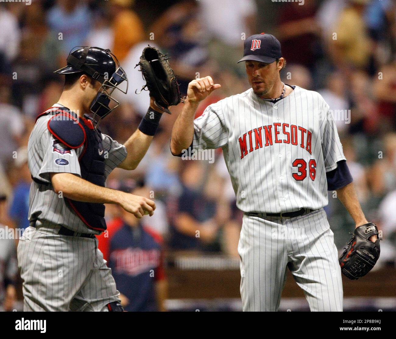 Minnesota Twins' Joe Mauer and pitcher Joe Nathan celebrate their 7-3 ...