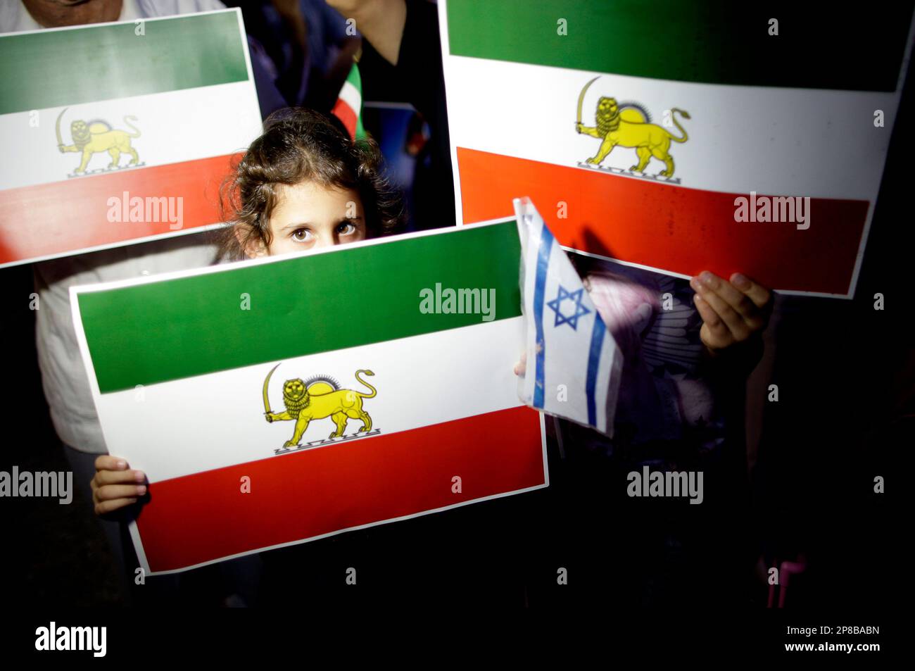 An Israeli girl of Iranian origin holds Israeli and Iranian pre-Islamic ...