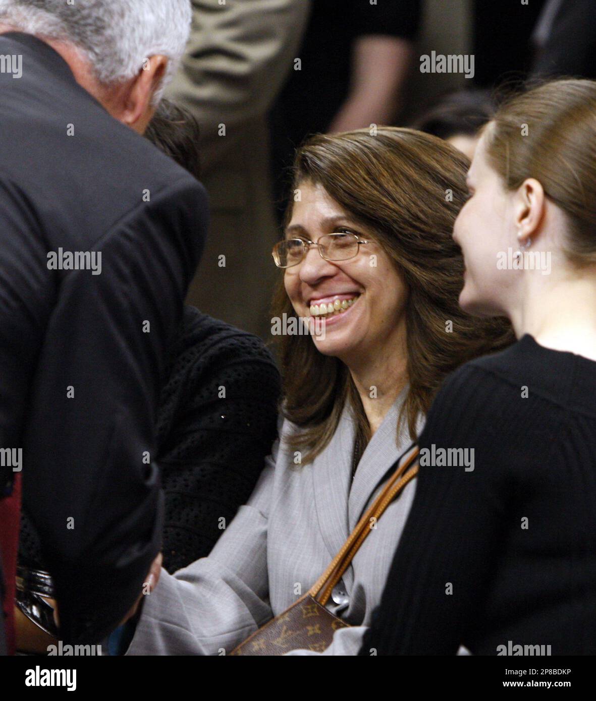 Carmen Guzman, mother of victim Julissa Brisman, center, smiles as she ...