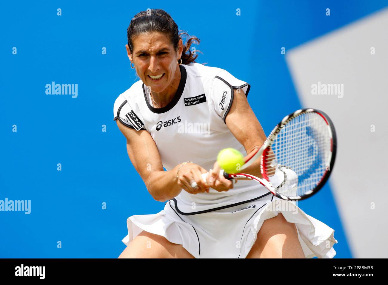 Virginie Razzano of France plays a return shot to Caroline Wozniacki of ...