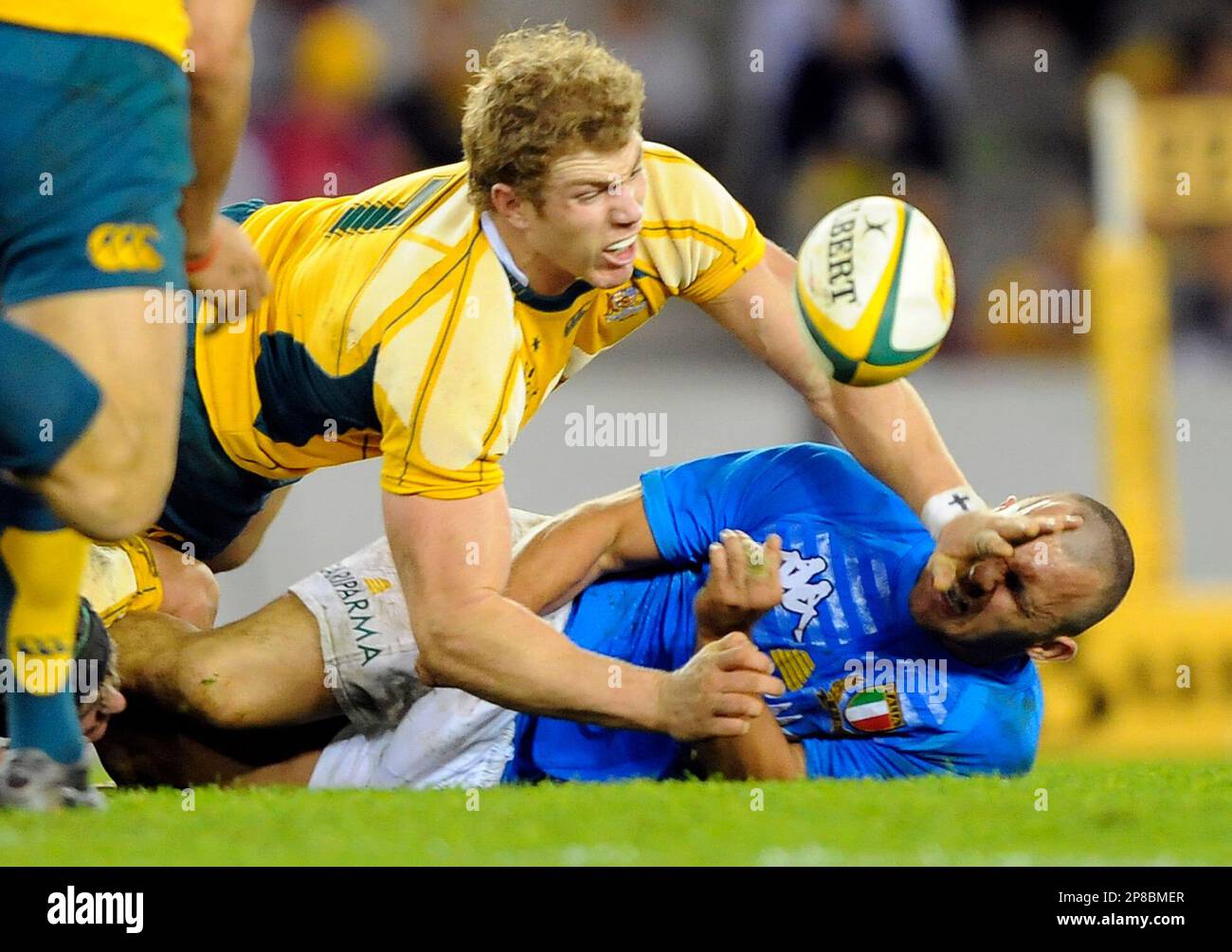 Australia's David Pocock, left, falls on Italy's Tito Tebaldi during ...