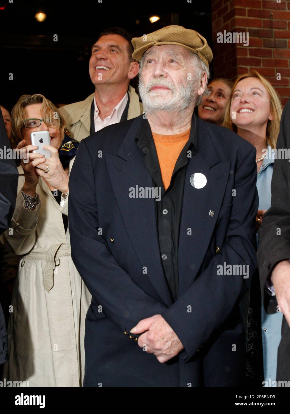 Artist Robert Indiana watches as his oversized EAT sign is illuminated ...