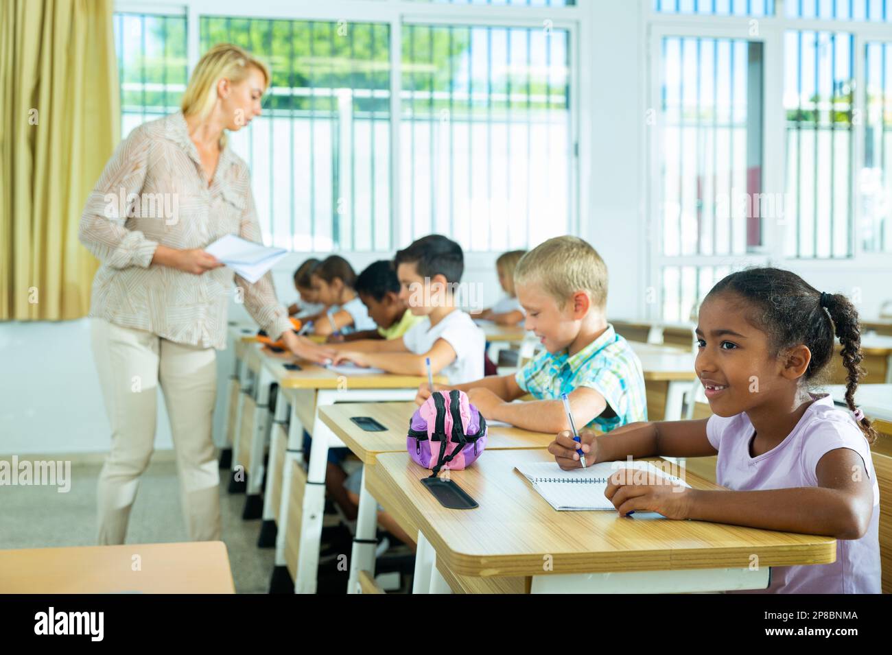 Side view of schoolkids group working on lecture in classroom Stock ...