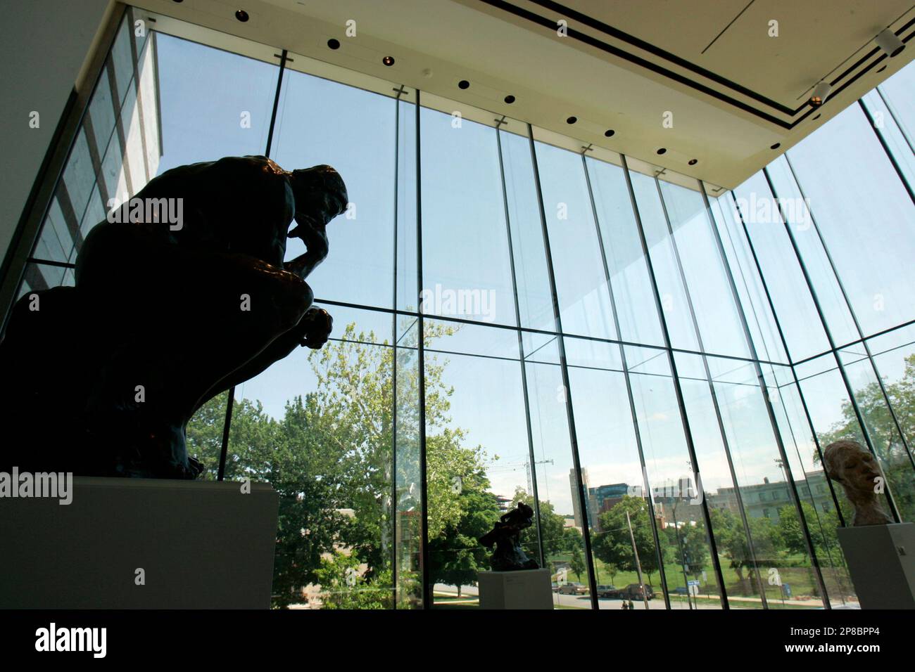 A bronze sculpture titled "The Thinker" by Auguste Rodin rests in the ...