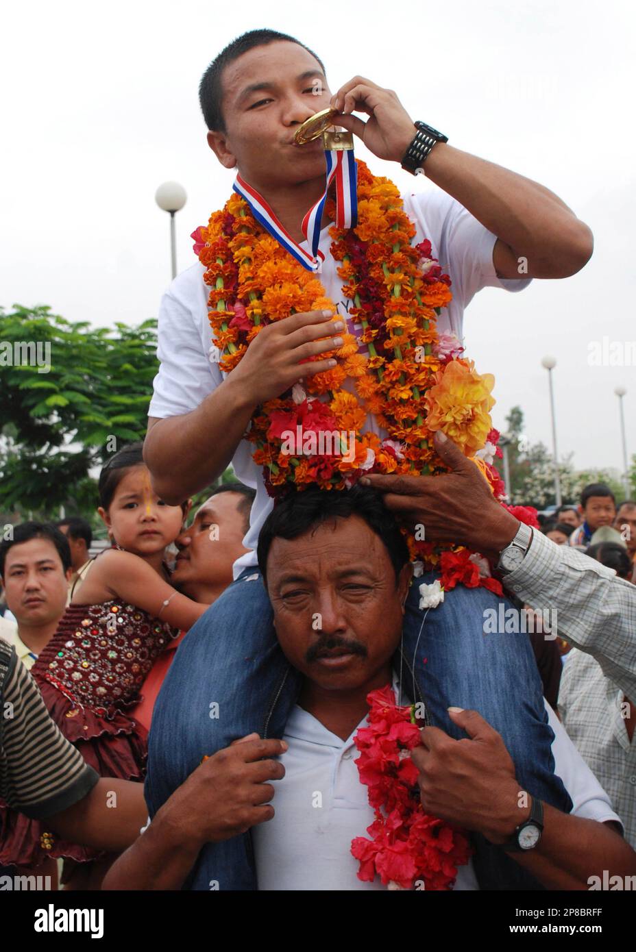 Gold medalist at the Asian Boxing Championship Suranjoy Singh kisses ...