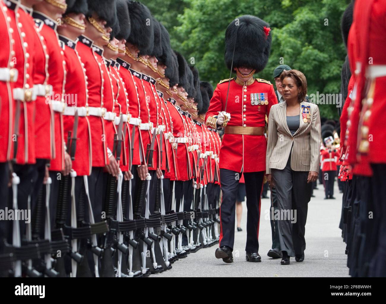 Canadian Governor General Michaelle Jean is escorted by Parade Commander Major Brian Hynes as ...