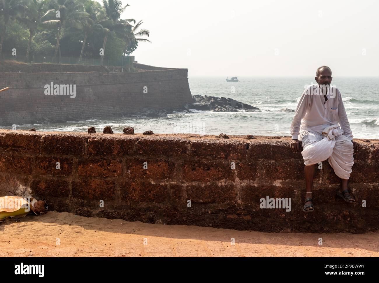 Candolim, Goa, India - January 2023: An elderly Indian man sitting ...