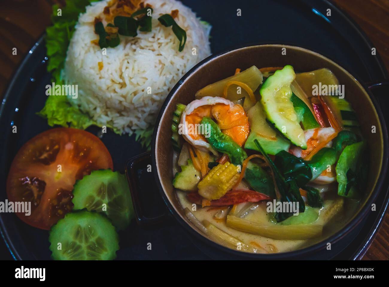 Thai green seafood curry with white rice and fresh salad. Asian healthy ...