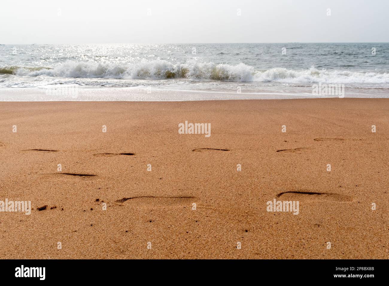 Footsteps on the sand beside the sea at the beautiful beach in ...