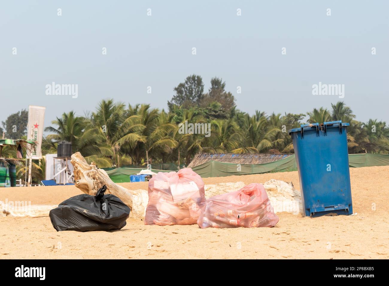 Candolim, Goa, India - January 2023: A dustbin and plastic bags full of ...