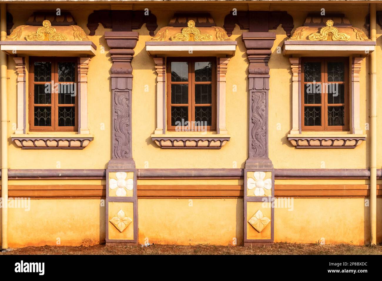 Exterior facade of an old colorful Goan style Hindu temple with ...