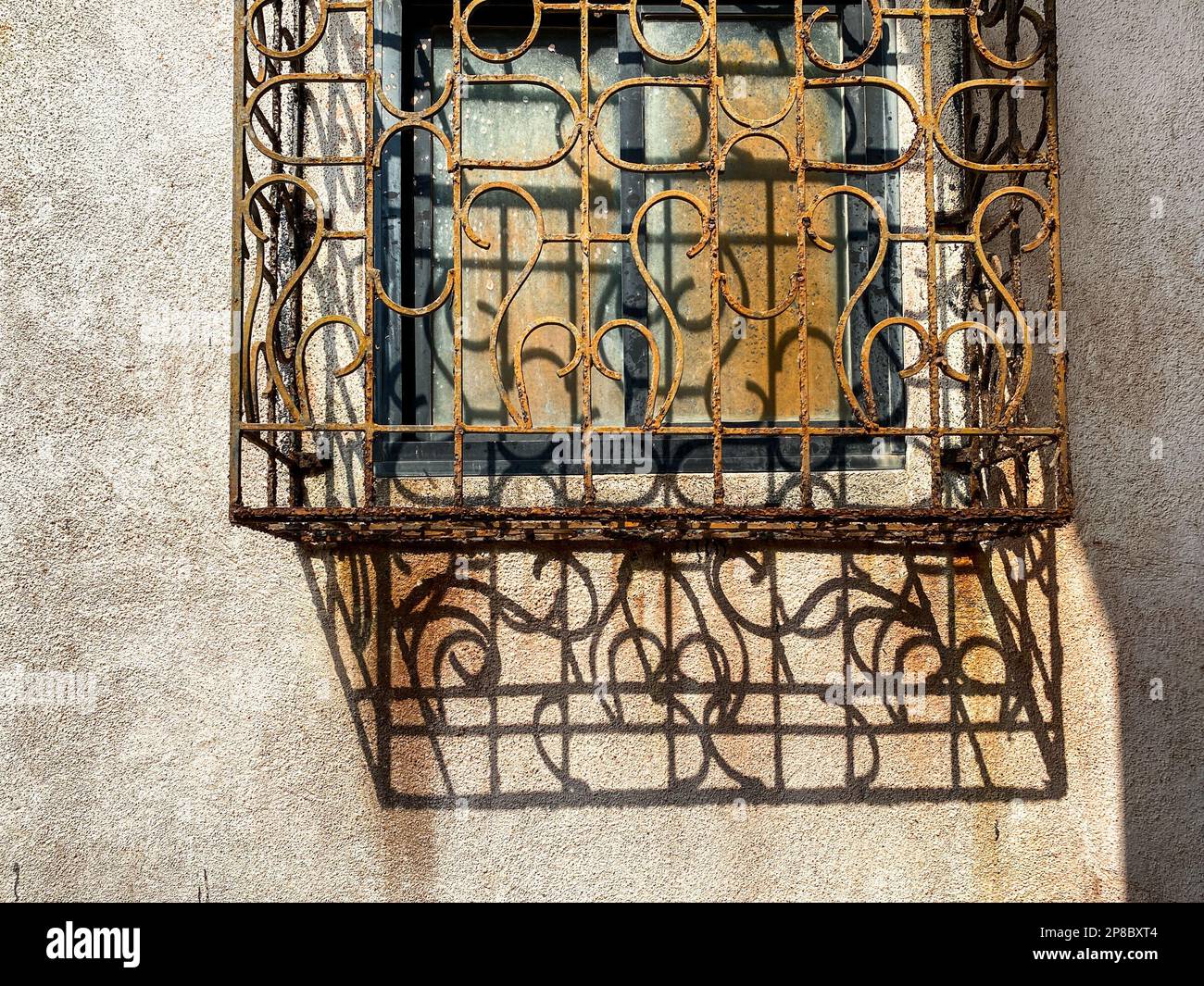 Texture and detail of an ornate vintage rusty metal grill of a window ...