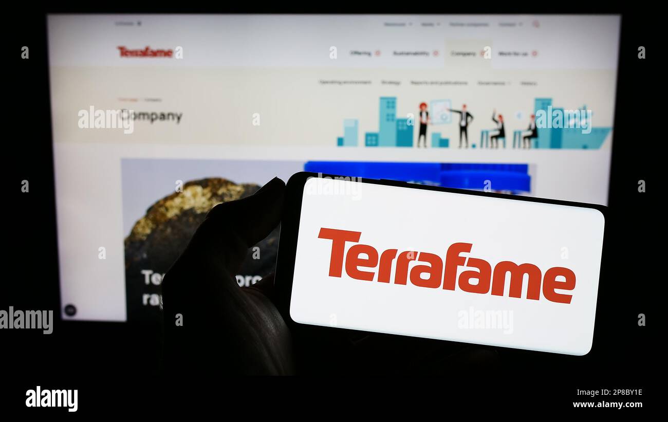 Person holding mobile phone with logo of Finnish battery chemicals ...