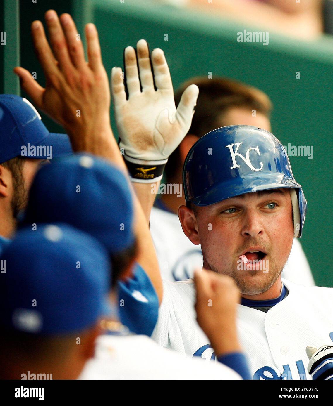 Kansas City Royals' Billy Butler is congratulated by teammates after ...