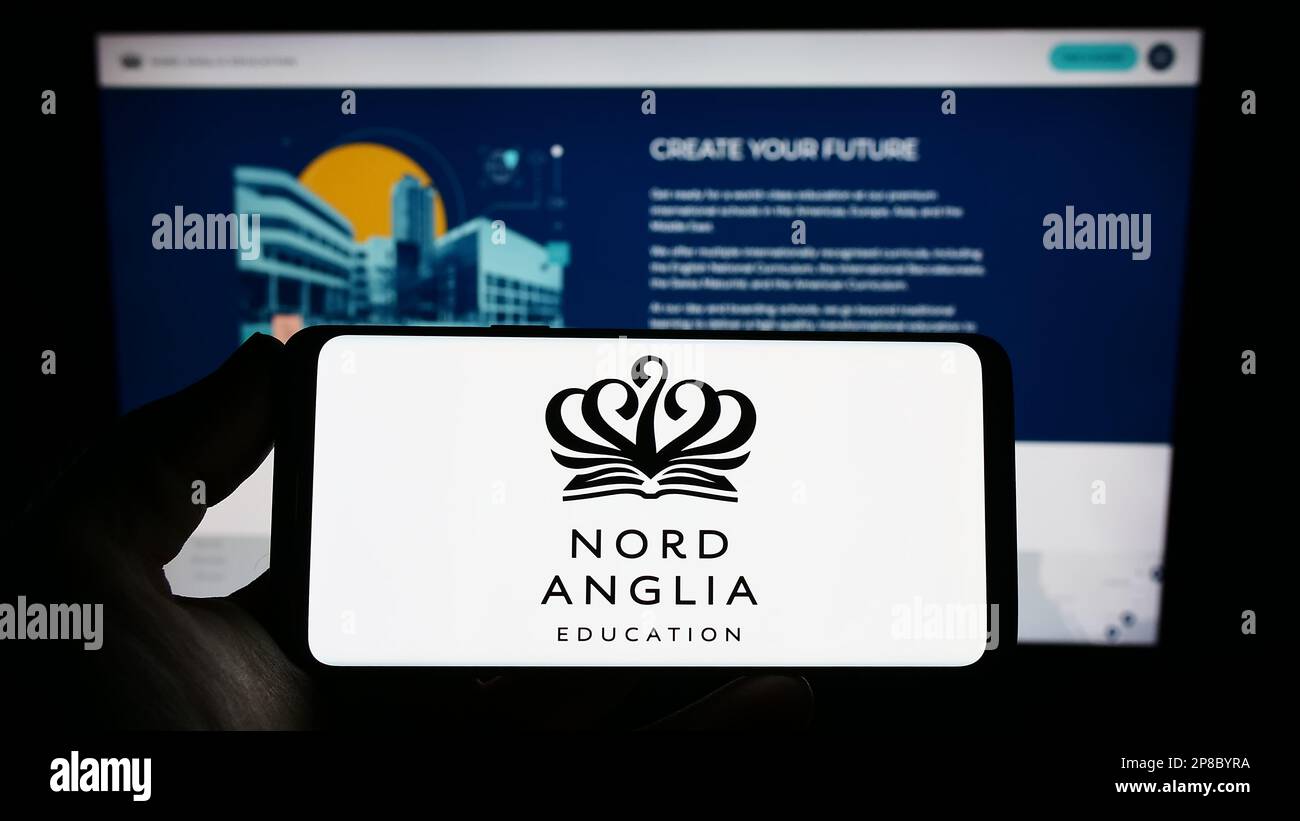 Person holding smartphone with logo of schooling company Nord Anglia ...