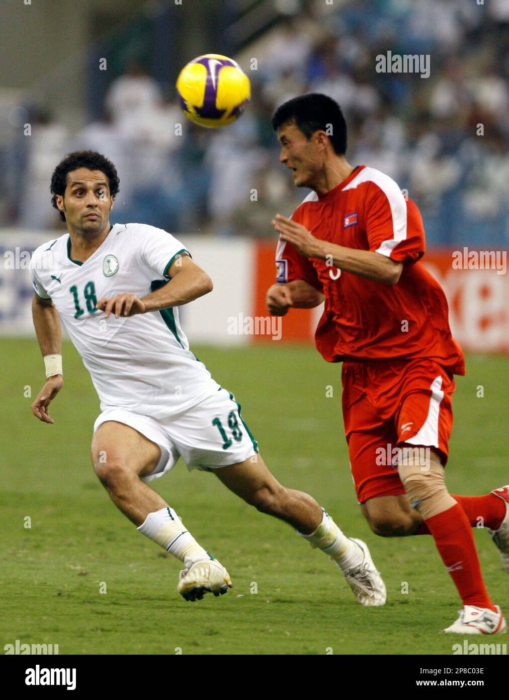 Saudi Arabia Yasser el-Qatani, left tries to block North Korea Ri Jun Li during the Asian Group ...