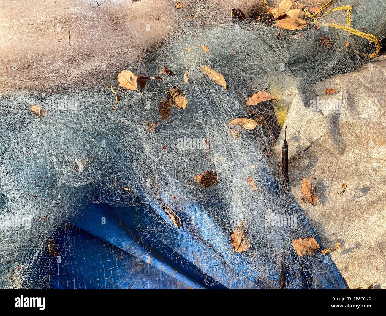 Detail of the meshes of the tangled fishing nets in a coastal village ...