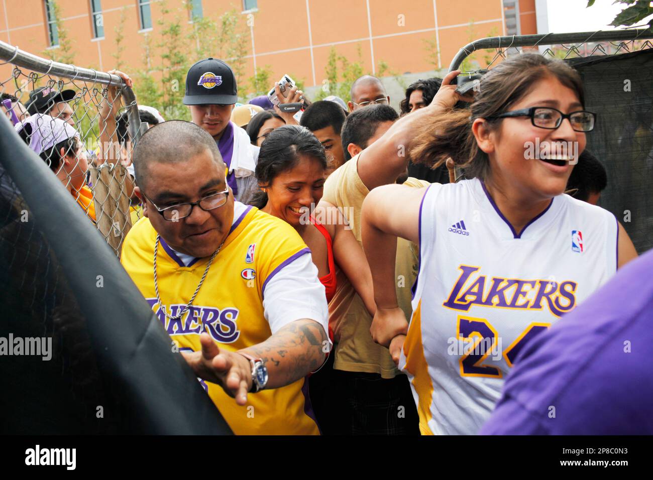Los Angeles Lakers basketball fans break through a chain link fence to ...