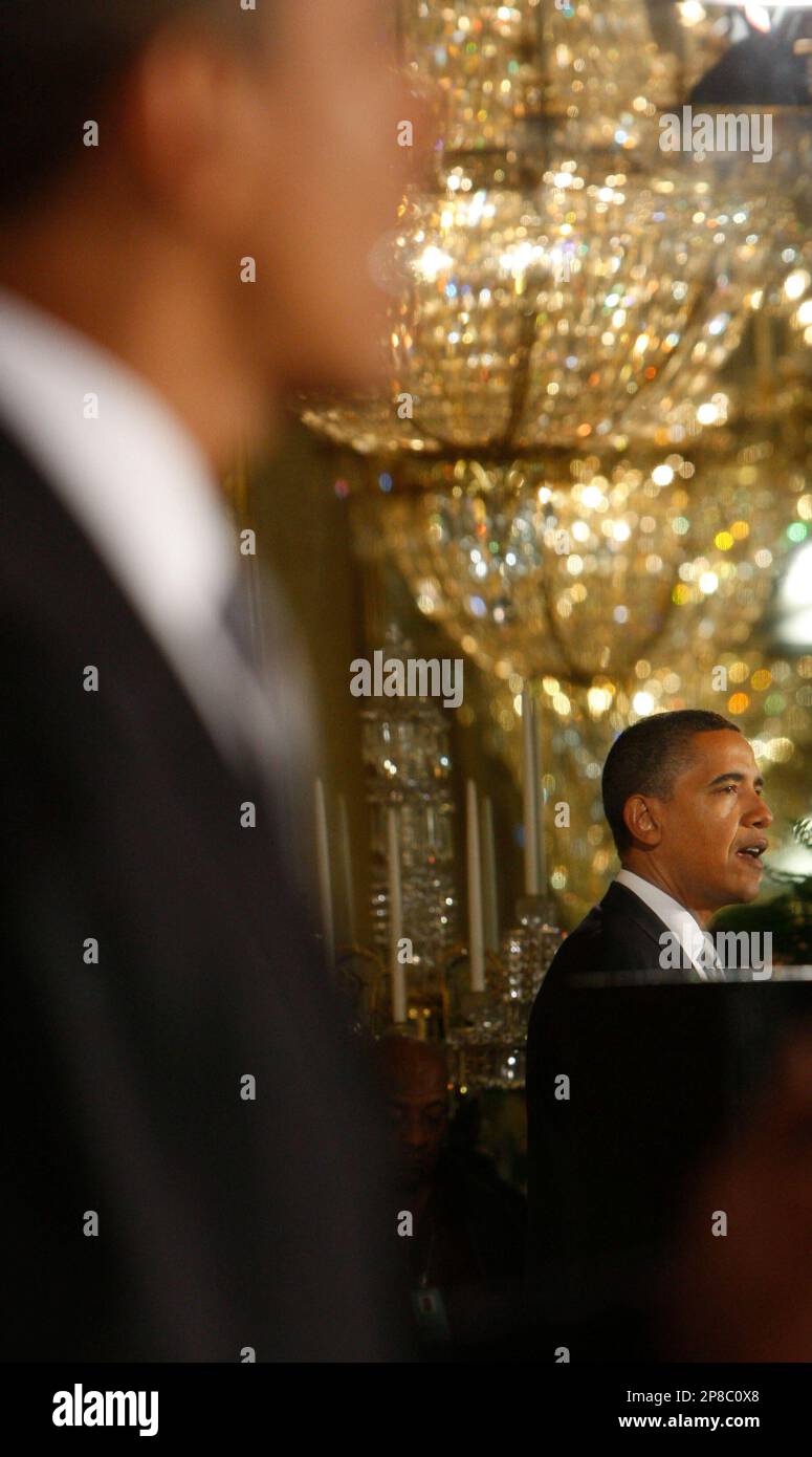 President Barack Obama is reflected in a mirror as he delivers remarks ...