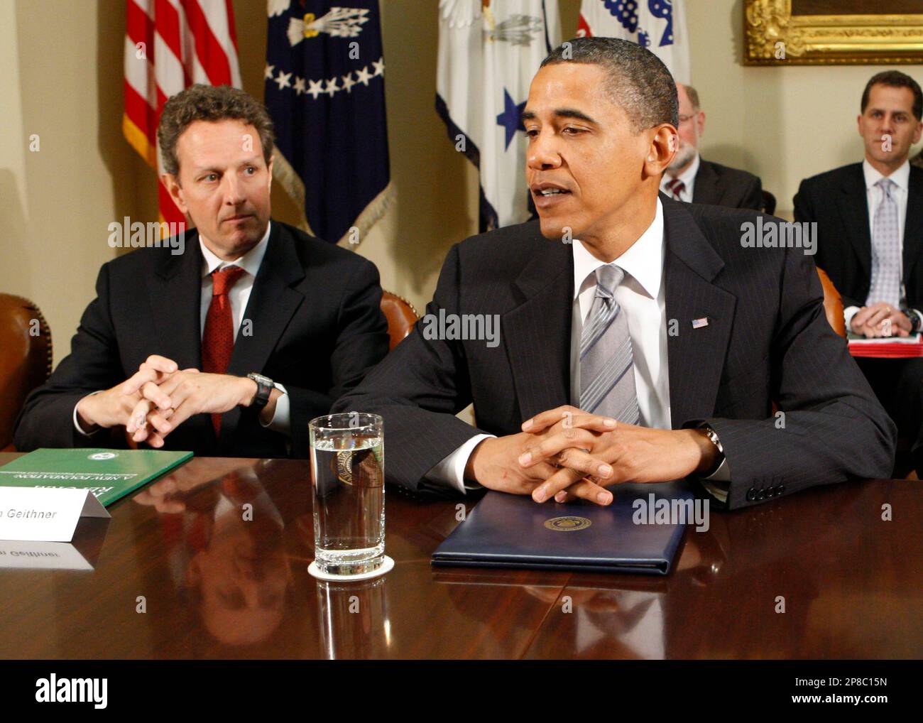 Treasury Secretary Timothy Geithner looks on as President Barack Obama ...