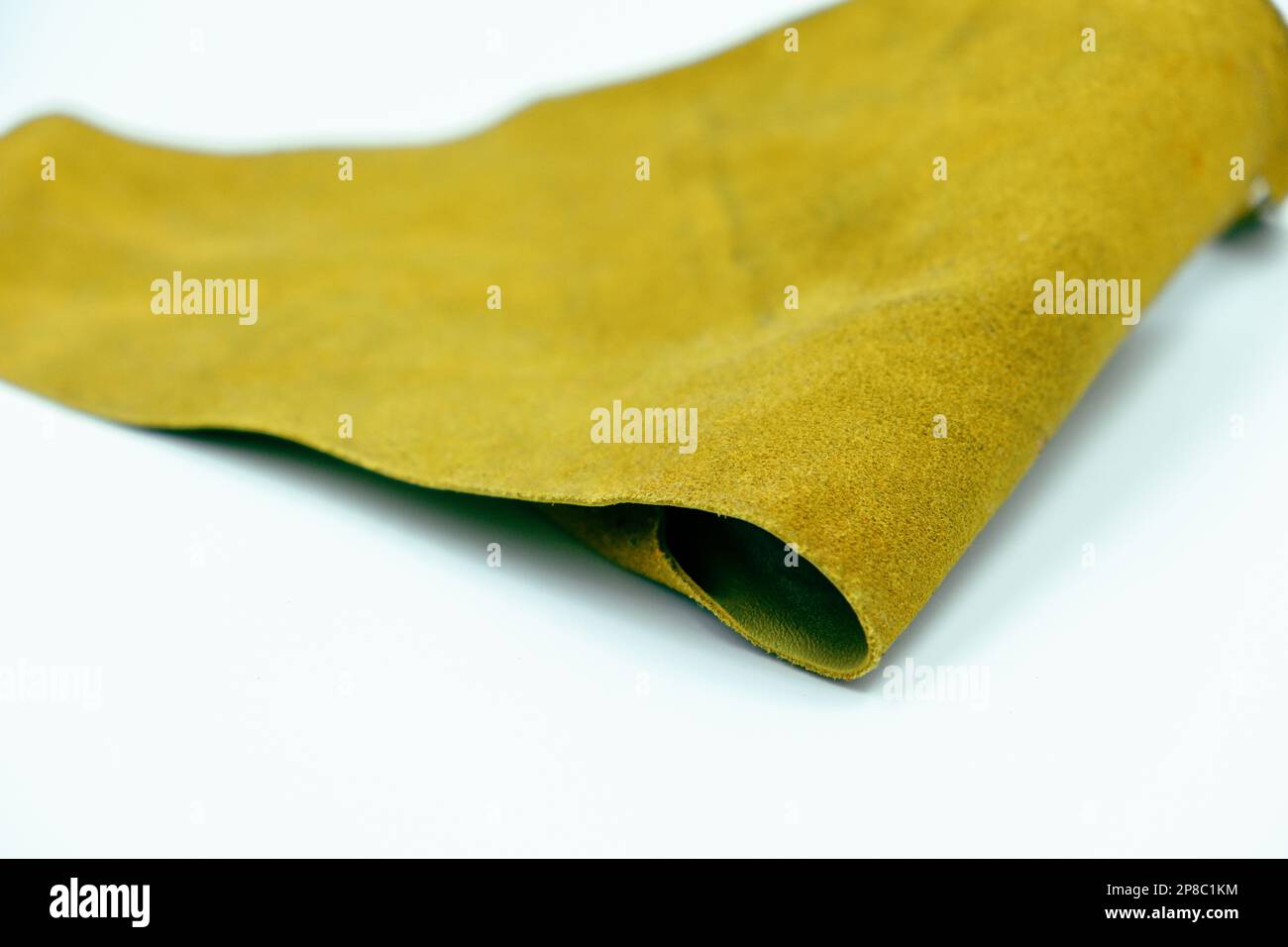 Genuine leather piece isolated on white background. Light green genuine ...