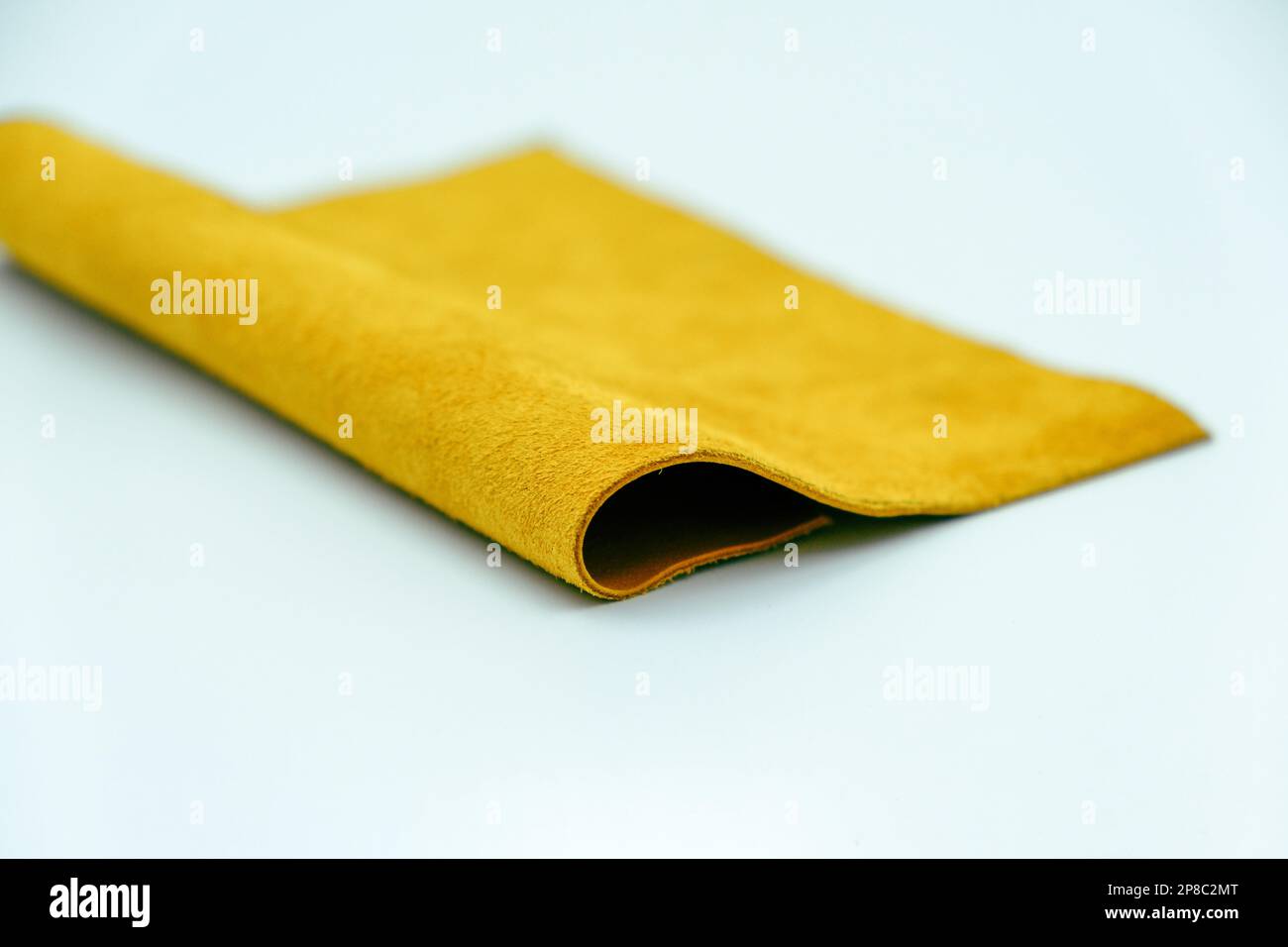 Genuine leather piece isolated on white background. Yellow genuine ...