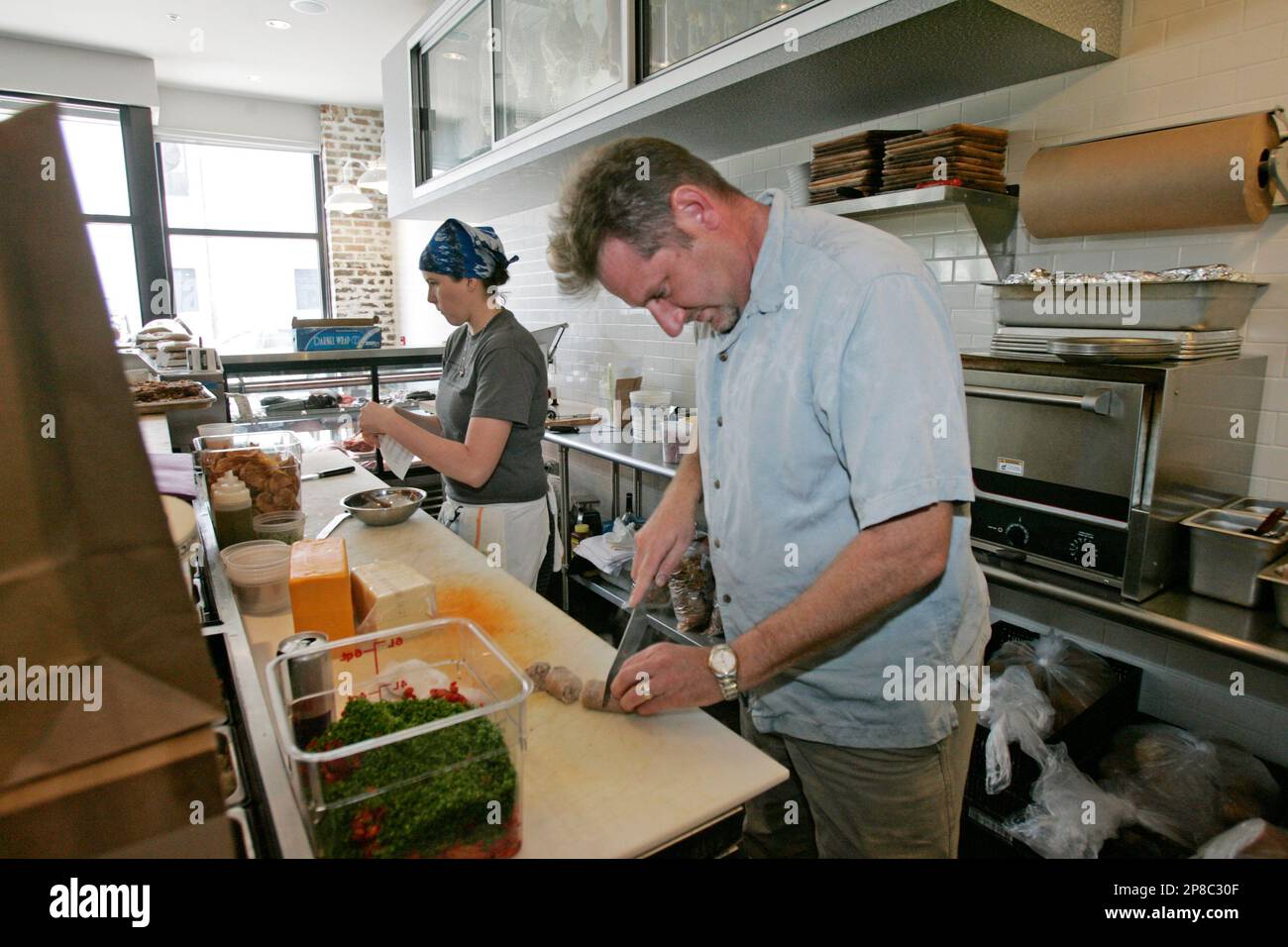 Chef Donald Link cuts a piece of boudin in his new business in New ...