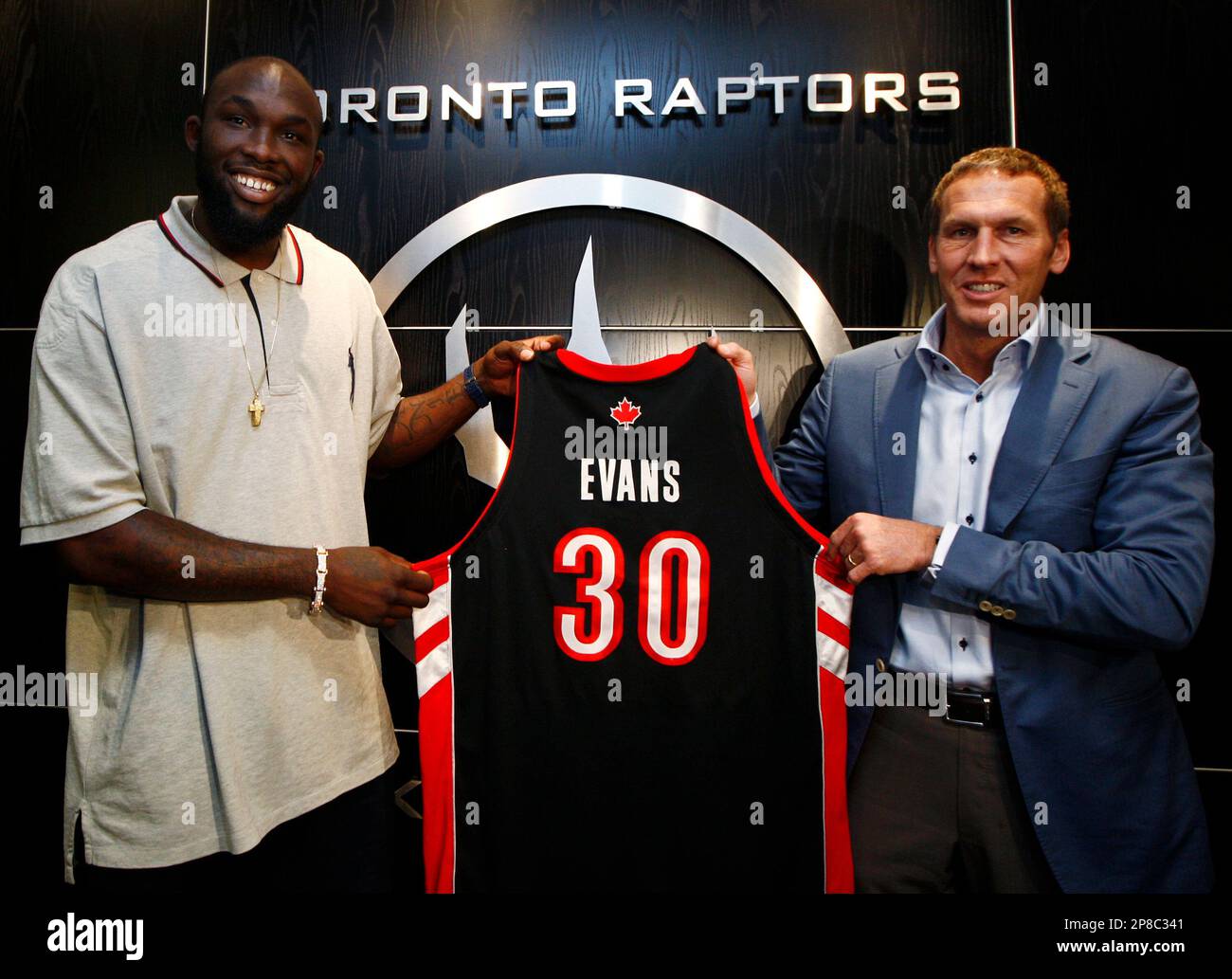 Newly-acquired Toronto Raptors forward Reggie Evans, left, and Raptors ...