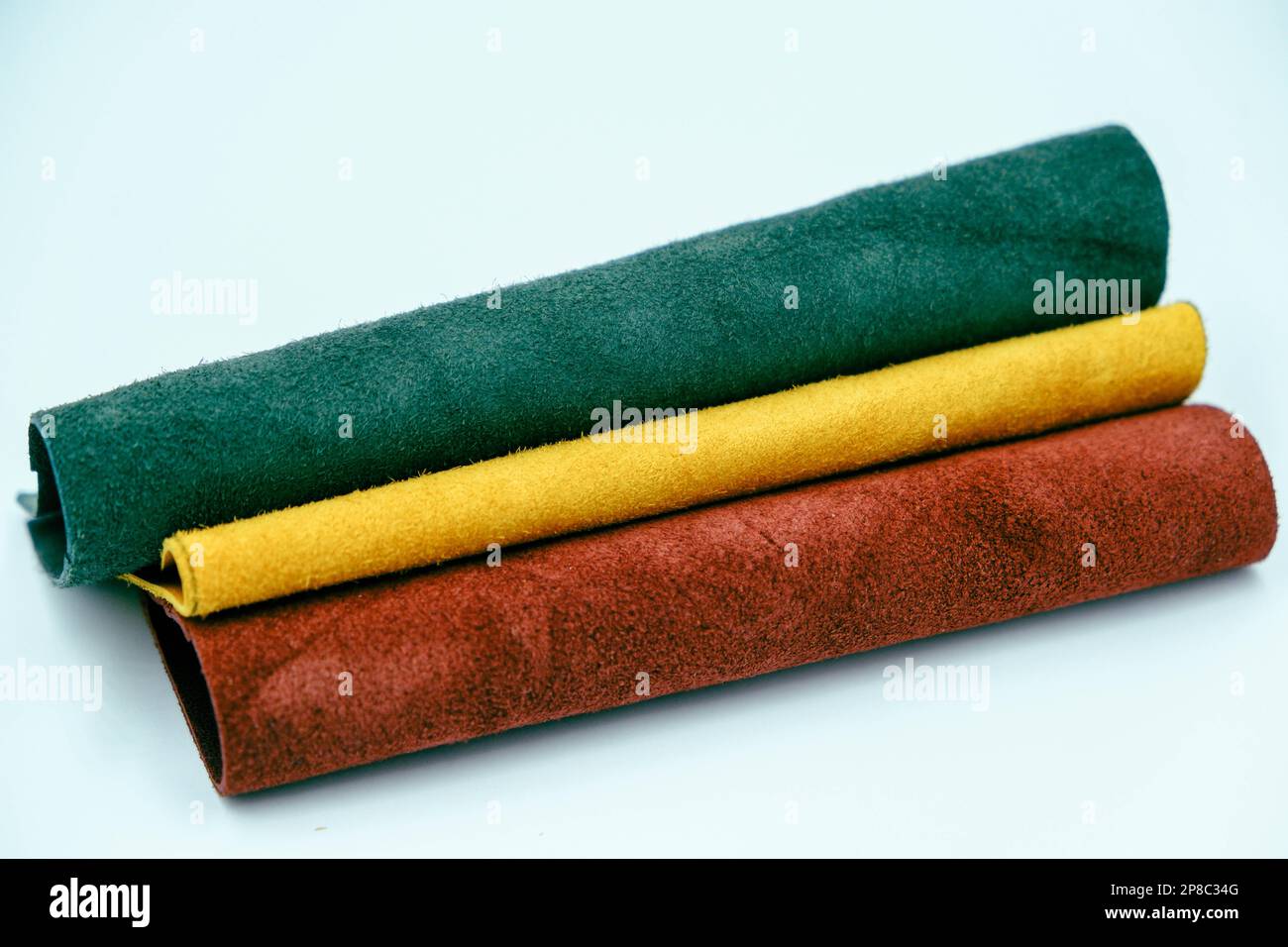 Genuine leather pieces isolated on white background. Green, yellow and ...