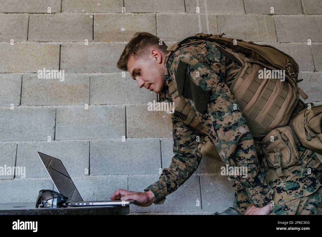 American soldier in military uniform using laptop computer for drone ...
