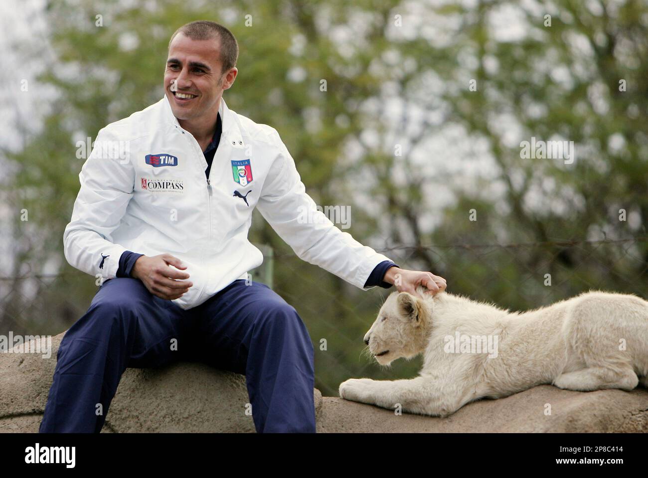 Italy's Fabio Cannavaro pets a lion cub during a visit at the Lion Park ...