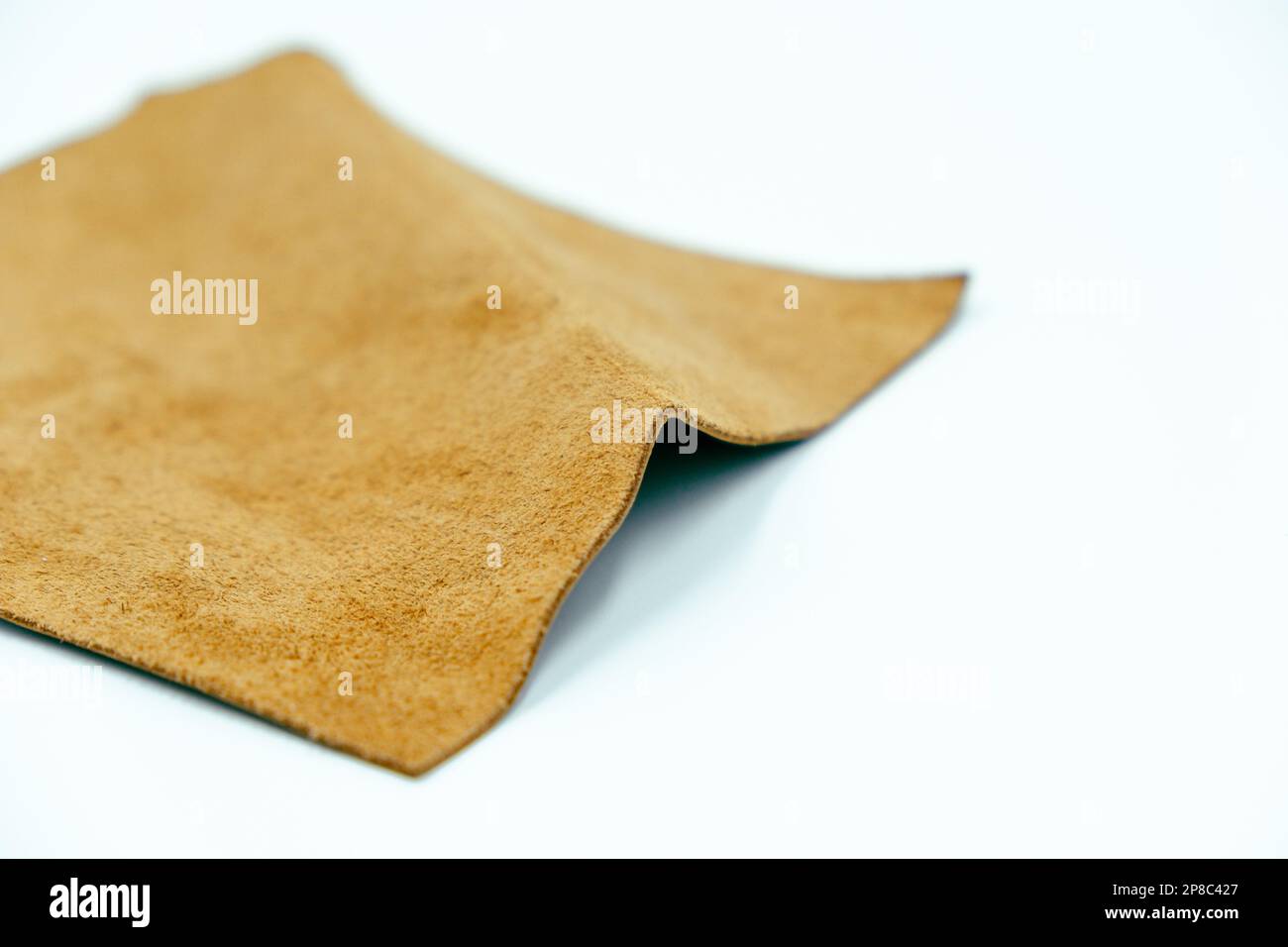 Genuine leather piece isolated on white background. Brown genuine ...