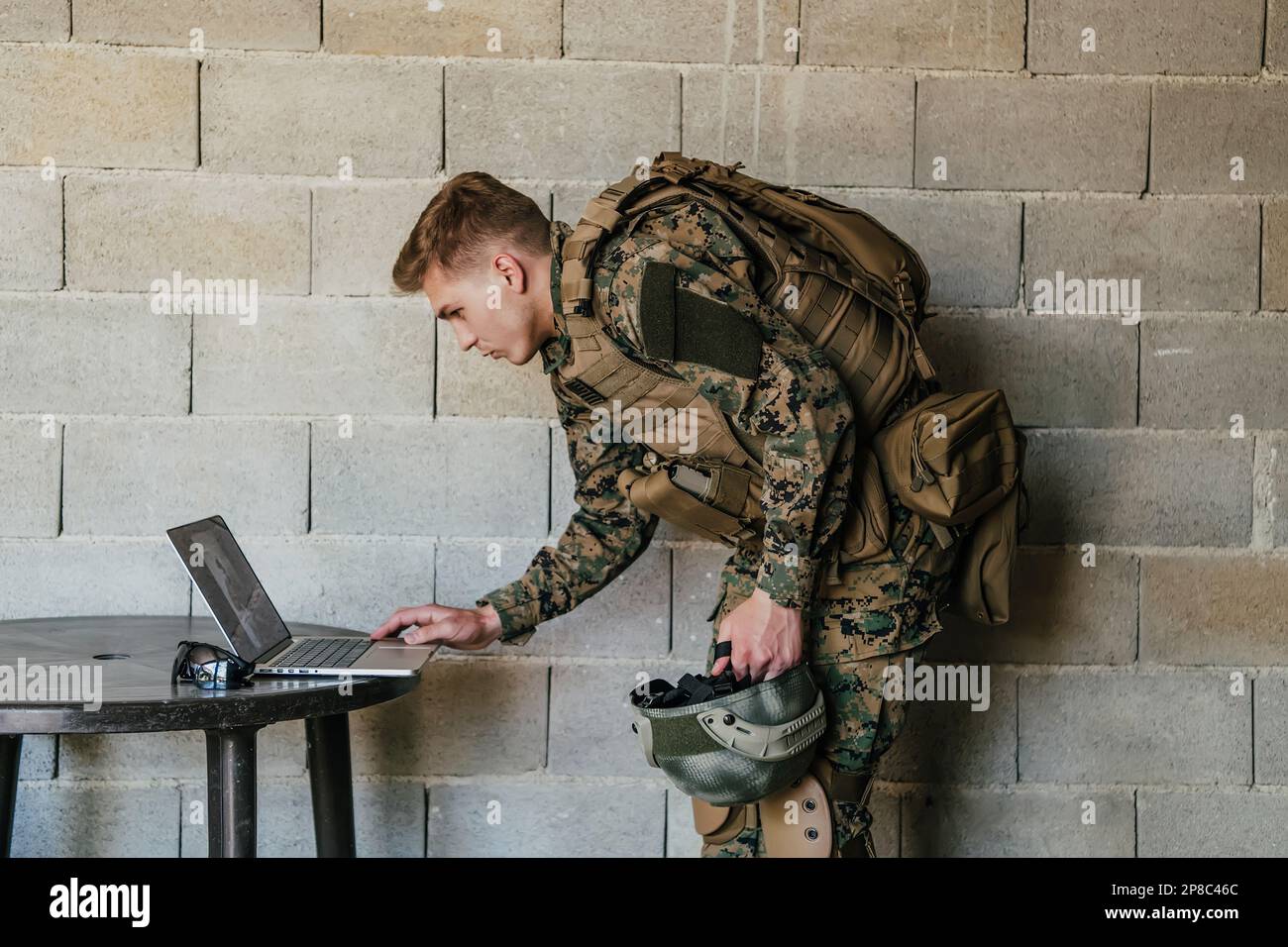 American soldier in military uniform using laptop computer for drone ...