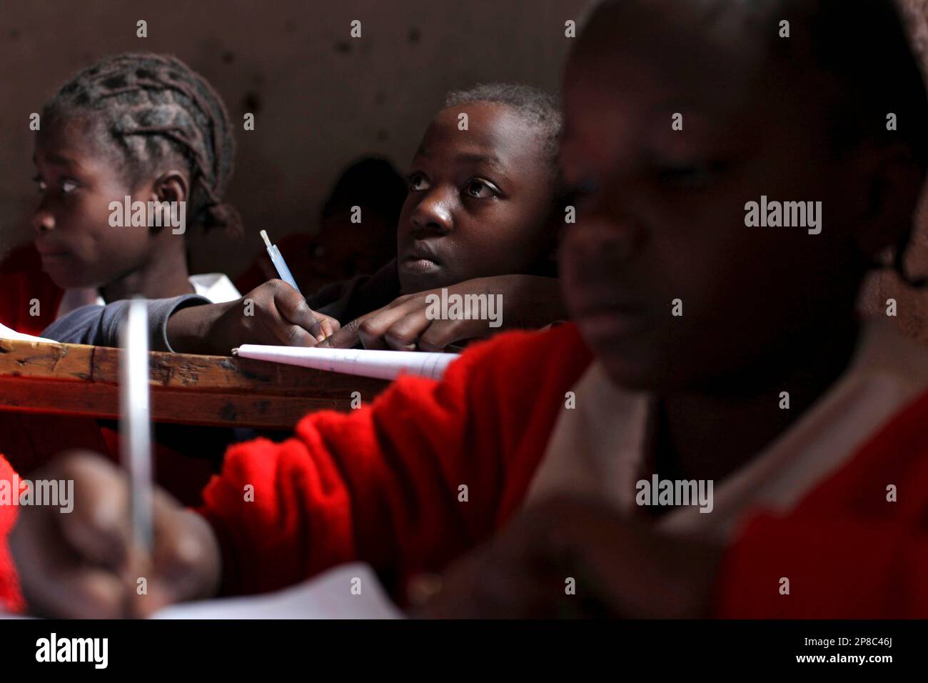 Children take notes during a lesson in a makeshift school Tuesday, June ...