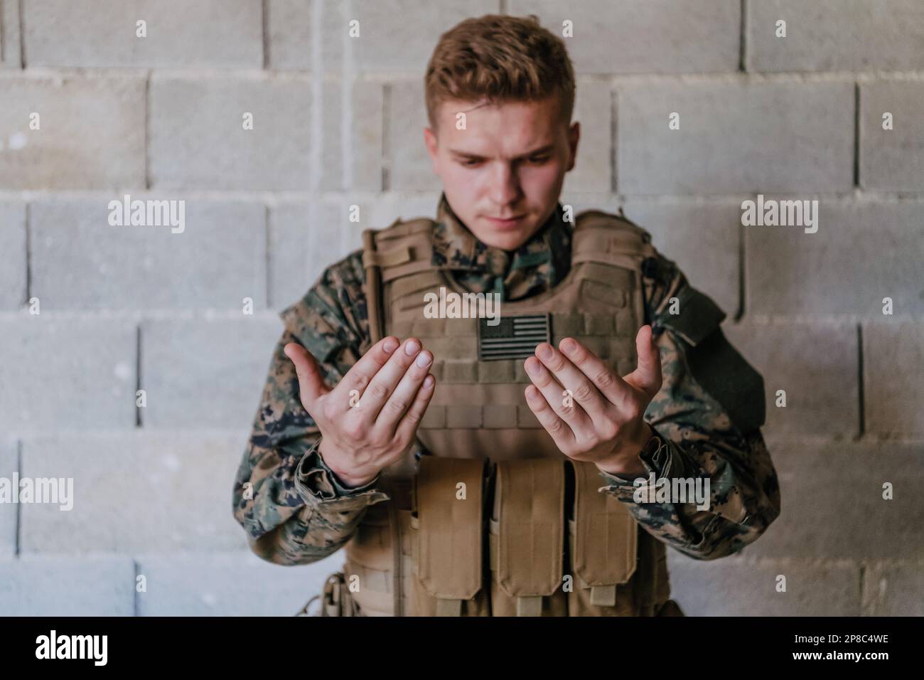 A Muslim soldier of the special forces prays to God by raising his ...