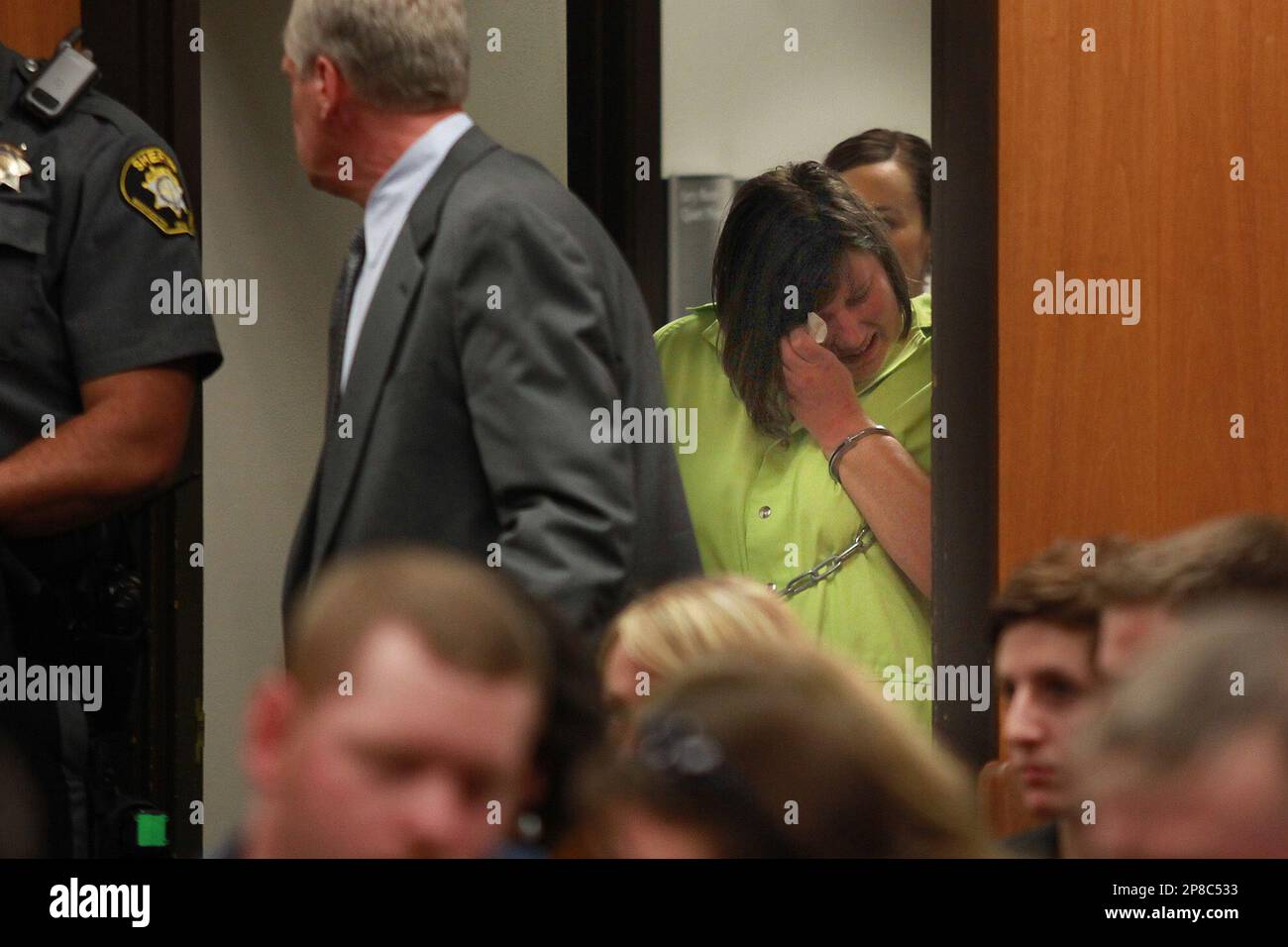 Korena Roberts wipes away tears as she enters the Washington County ...