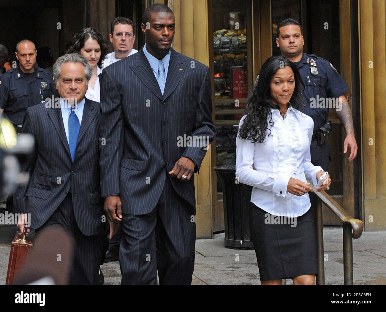 Former New York Giants wide receiver Plaxico Burress, center, exits ...