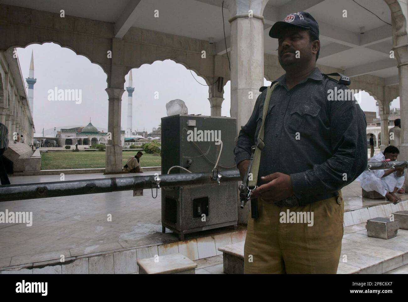 A Pakistani police officer stands guard at the main entrance of famous ...