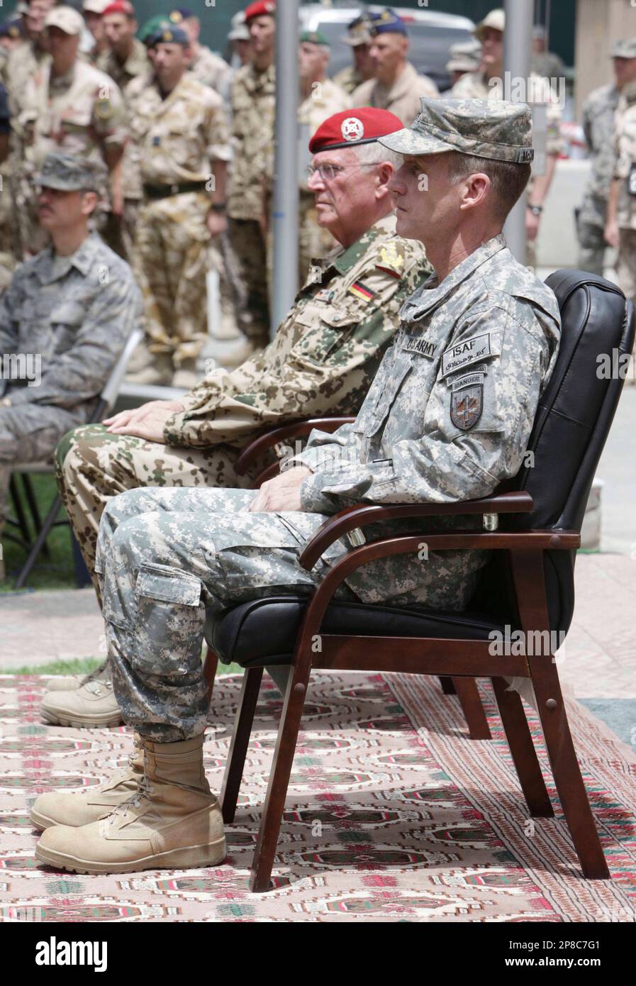 U.S. Gen. Stanley McChrystal, right, sits during his assumption of a ...