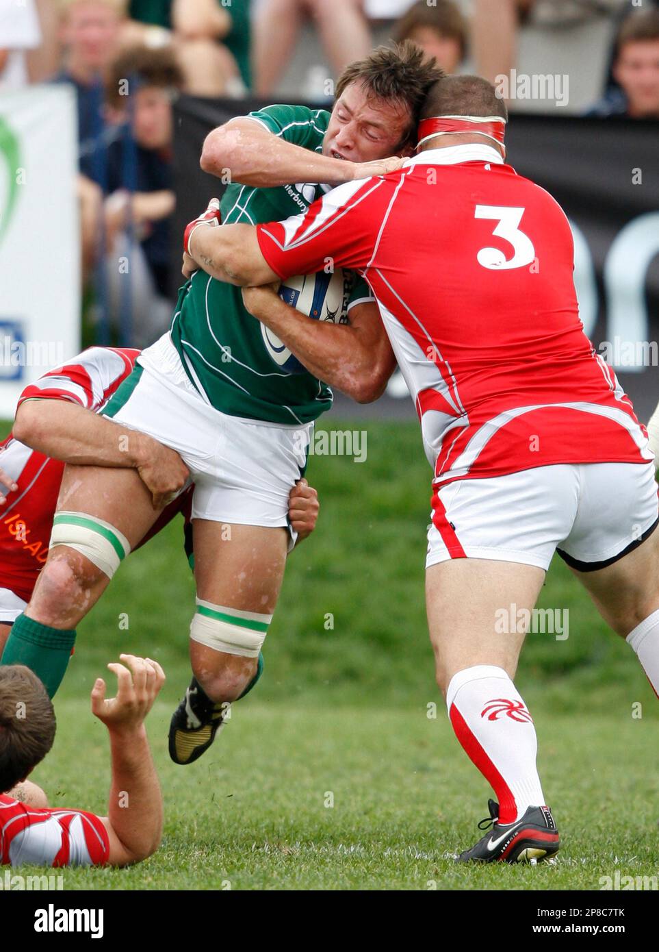 top Ireland A's Neil Best , left, is wrapped up by Georgia's George ...