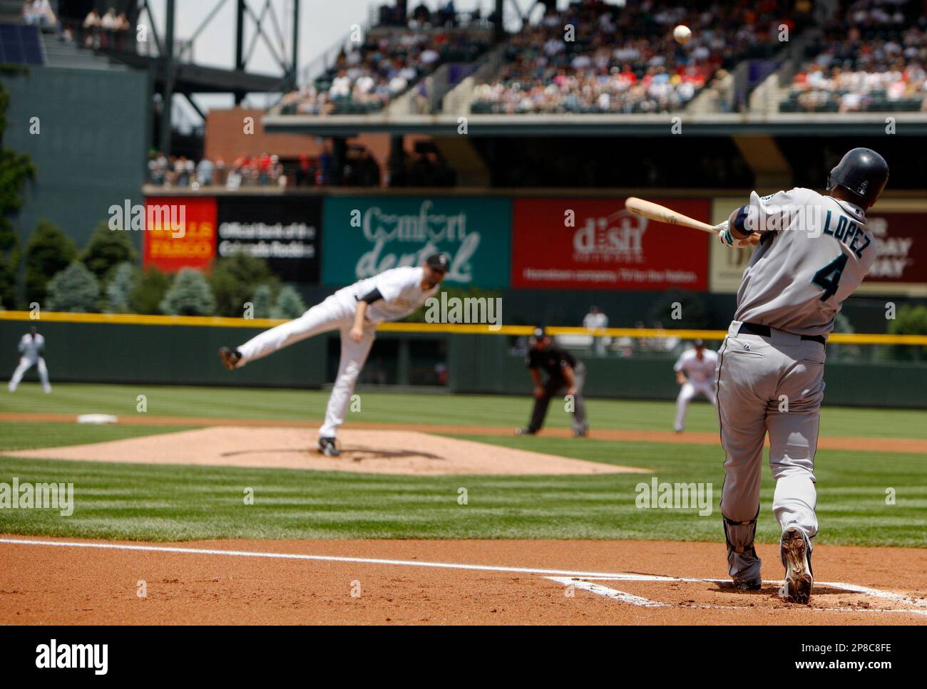 Seattle Mariners' Jose Lopez, front, connects for a sacrifice fly to ...