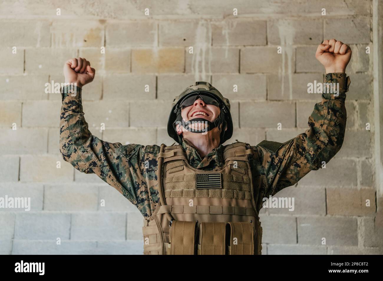 Success in the war campaign. A soldier with raised hands celebrates the ...