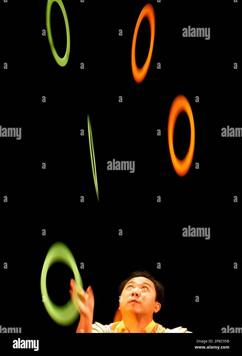 Wang Dongge, a member of China's Guangzhou Acrobatic Troupe, juggles ...