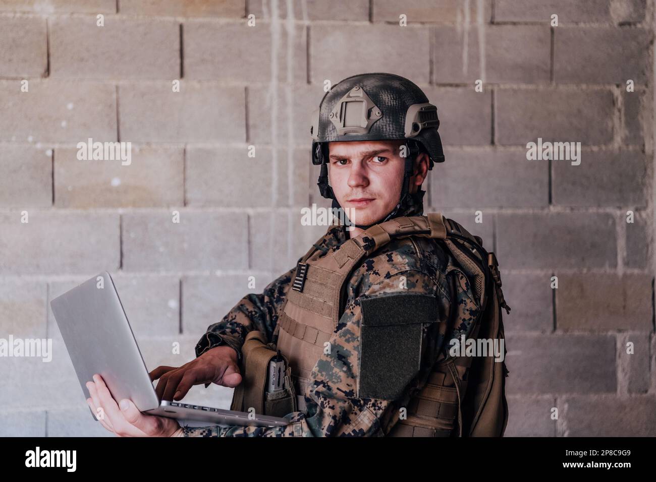 American soldier in military uniform using laptop computer for drone ...