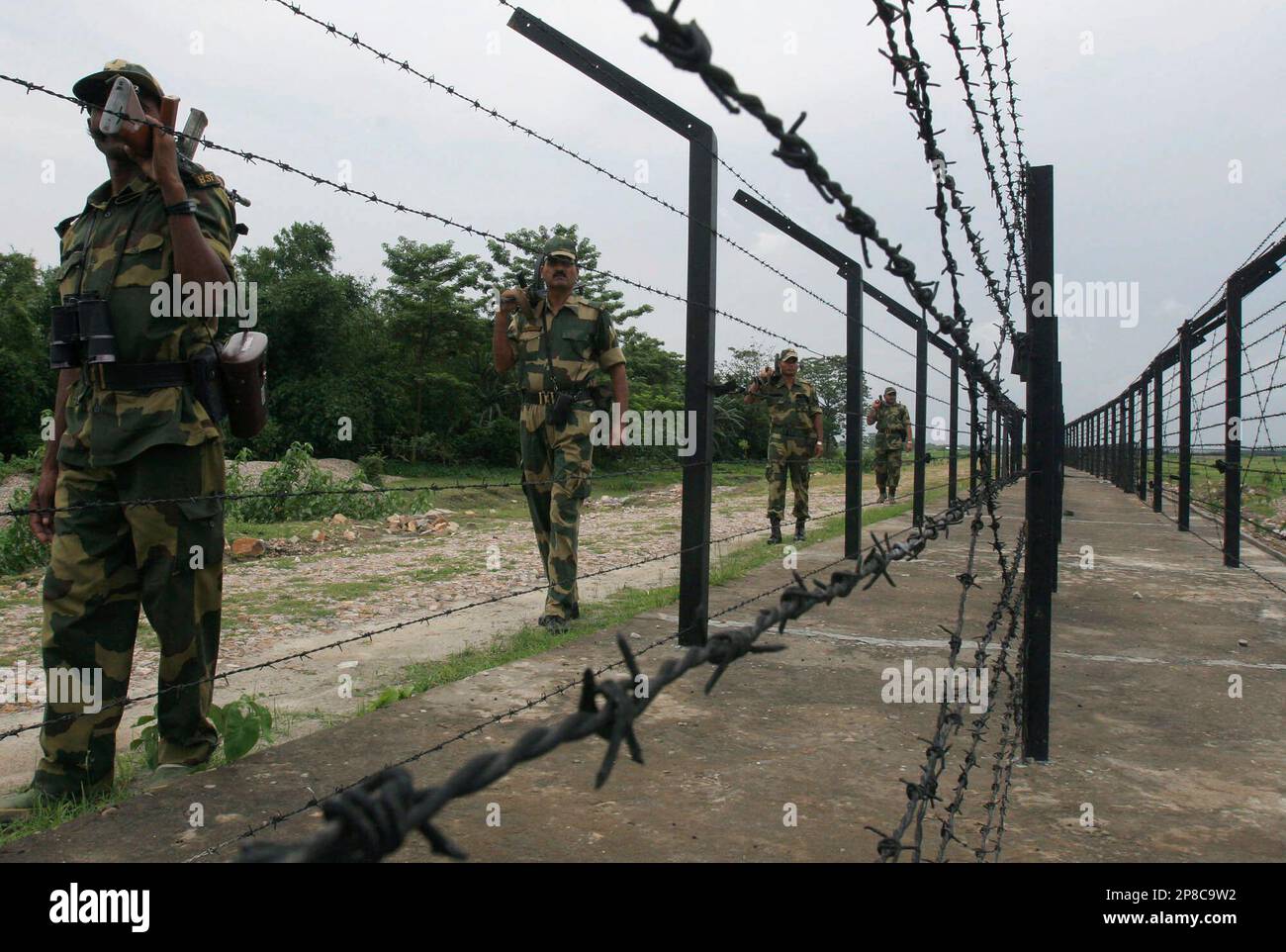 Border Security Force soldiers patrol at the newly constructed fence ...