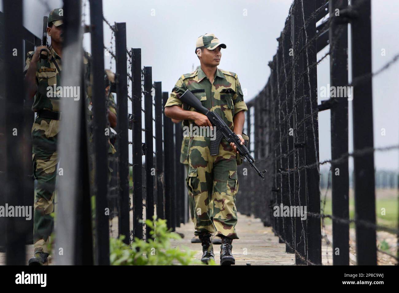 Border Security Force soldiers patrol at the newly constructed fence ...